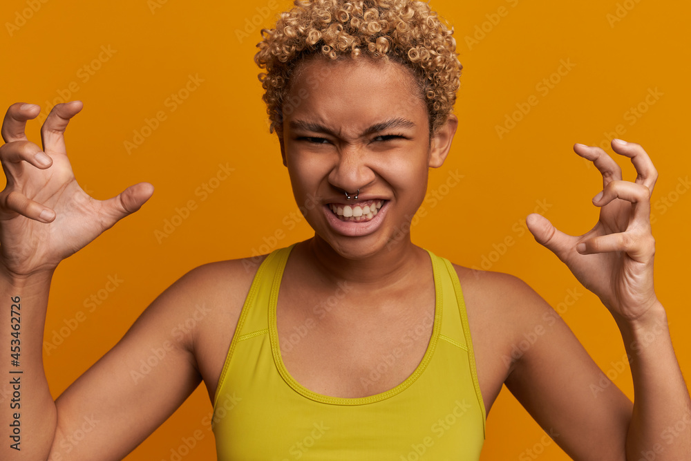 Horizontal portrait of dark-skinned girl roaring with anger and ...