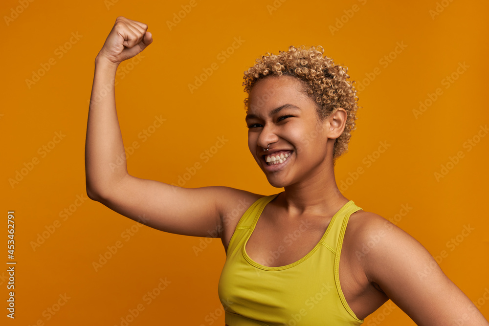 Sporty-looking slim female fitness guru in perfect shape posing with ...