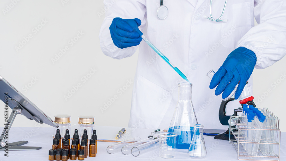 The pipette lowers the sample into the test tube. Close-up scientists ...