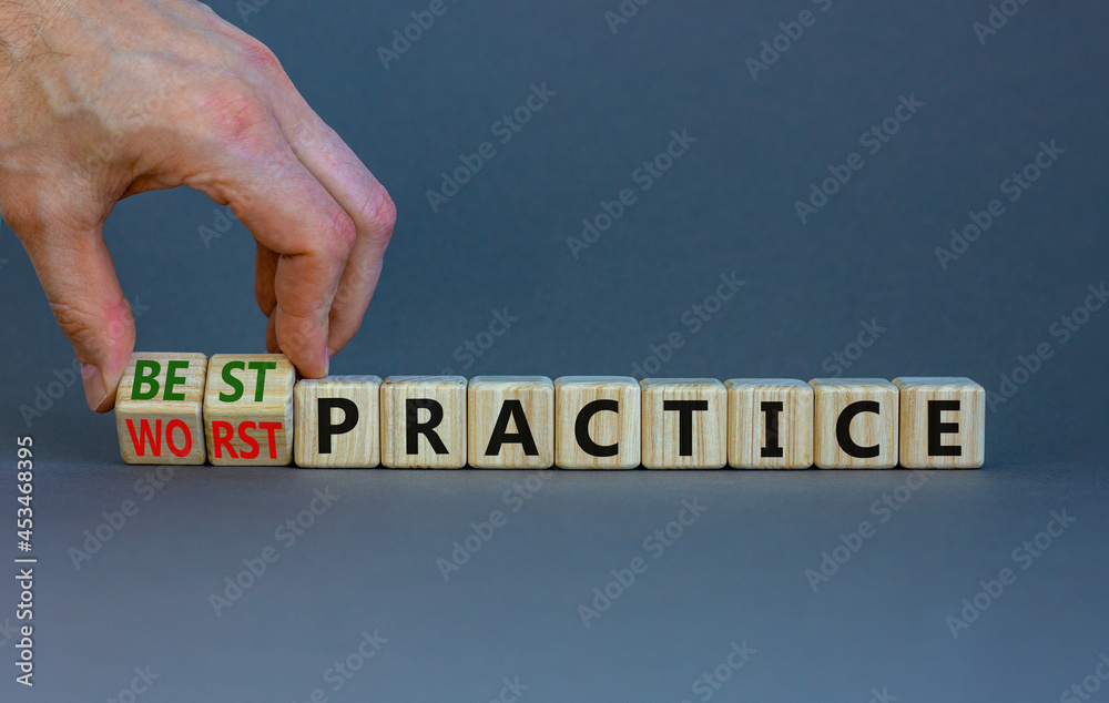 Best or worst practice symbol. Businessman turns wooden cubes and ...