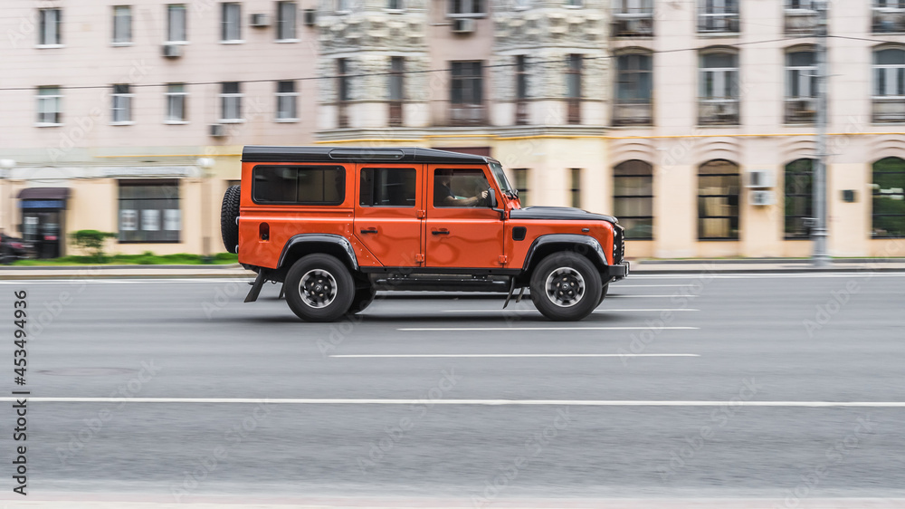Land Rover Defender 110 is driving on Moscow streets with blurred ...