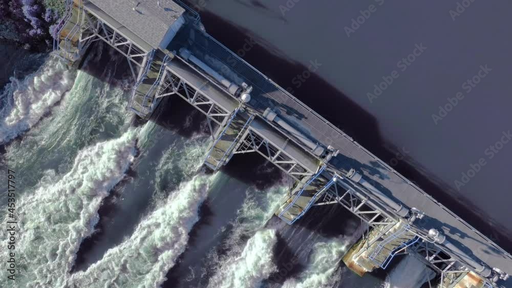 Water flowing over dam, aerial view looking straight down. This ...