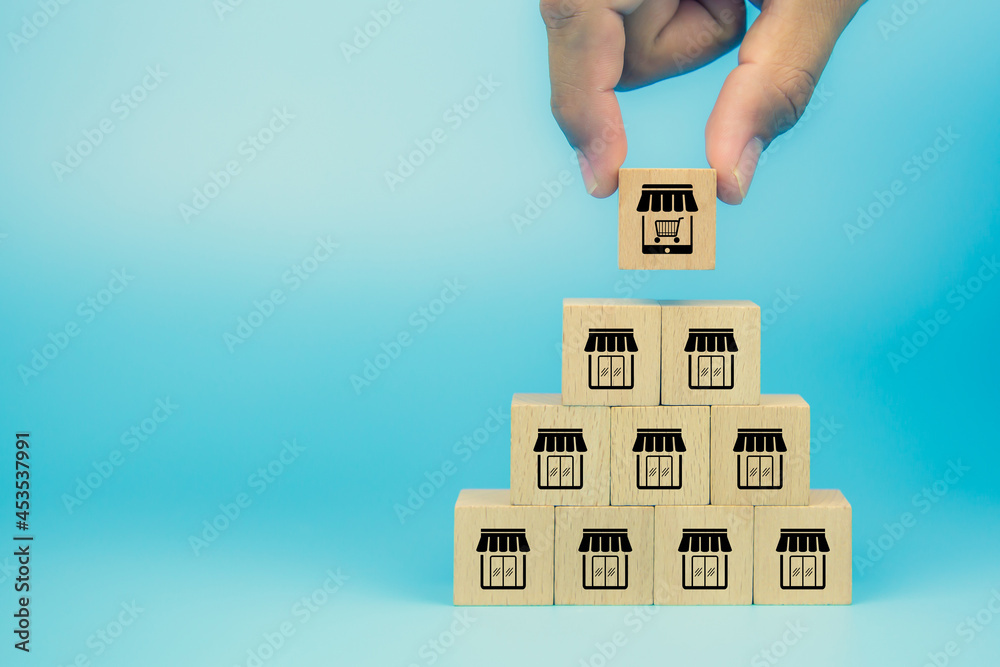 Franchise e-commerce, Hand choose cube wooden block stack with ...