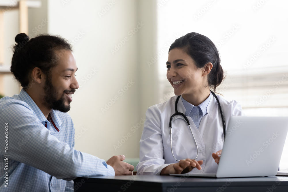 Happy millennial african american patient discussing computer ...