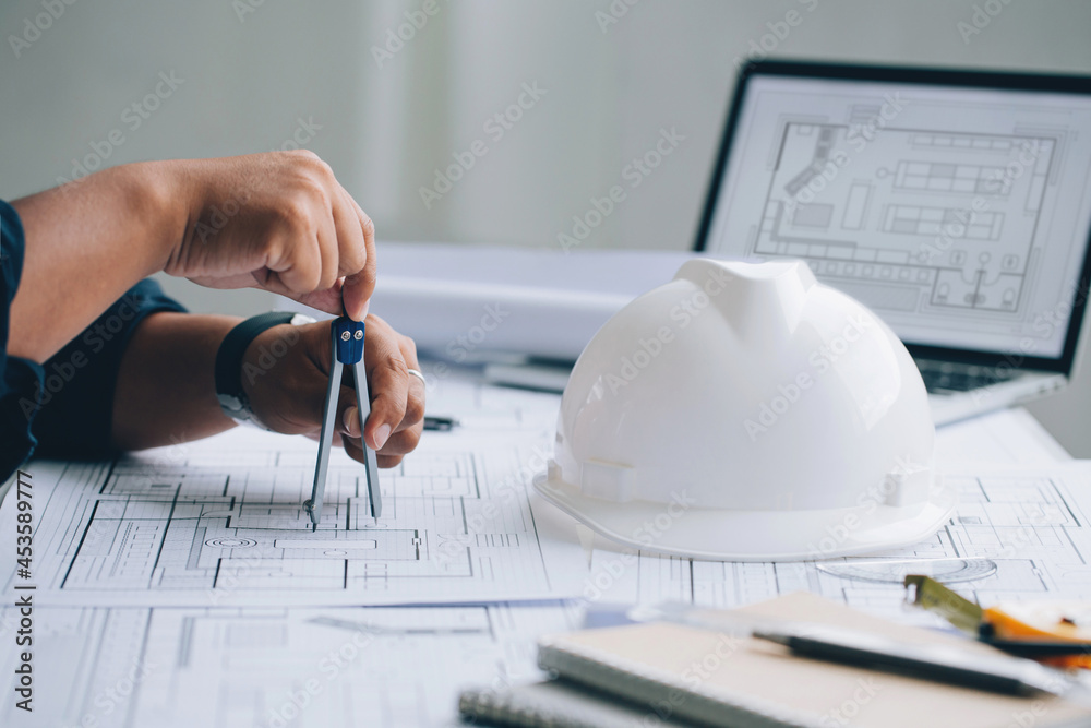 Architect man sketching architectural project on blueprint ...