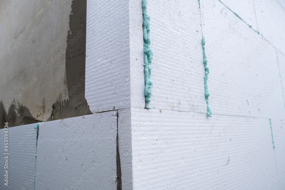 Installation of styrofoam insulation sheets on house facade wall for ...
