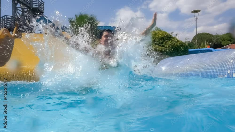 Descent from the waterslide on holiday aqua park. Slow motion on a ...