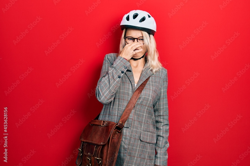 Beautiful caucasian blonde business woman wearing bike helmet smelling ...