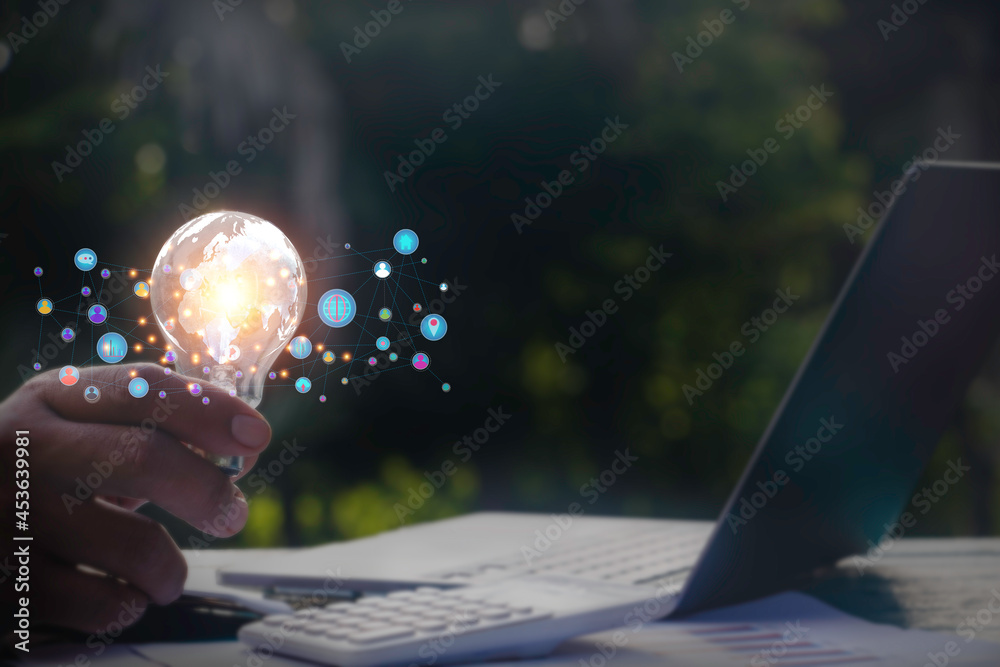 Hand hold light bulb with laptop wooden table.Creative thinking ideas ...