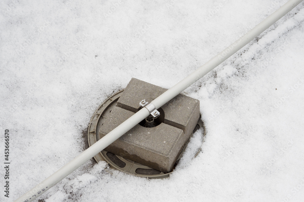 Concrete foot holding a covered lightning conductor wire on the roof ...