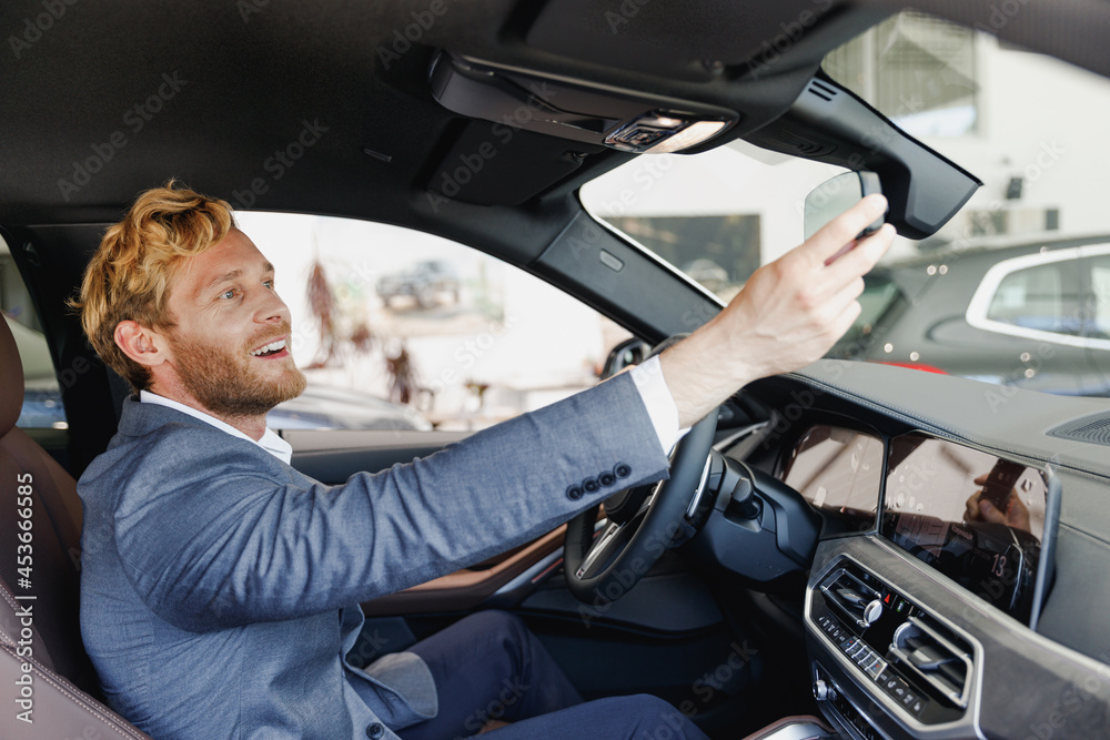 Side view man driver male cabdriver in classic grey suit drive car hold ...