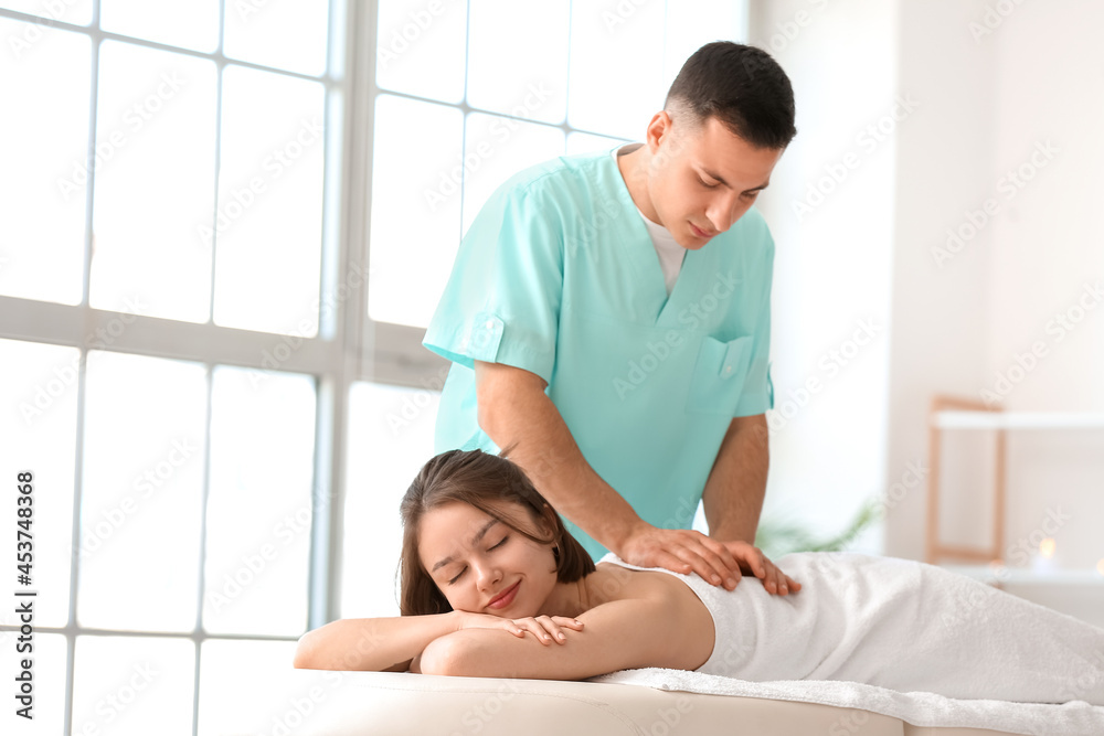Massage therapist working with patient in medical center Stock Photo ...