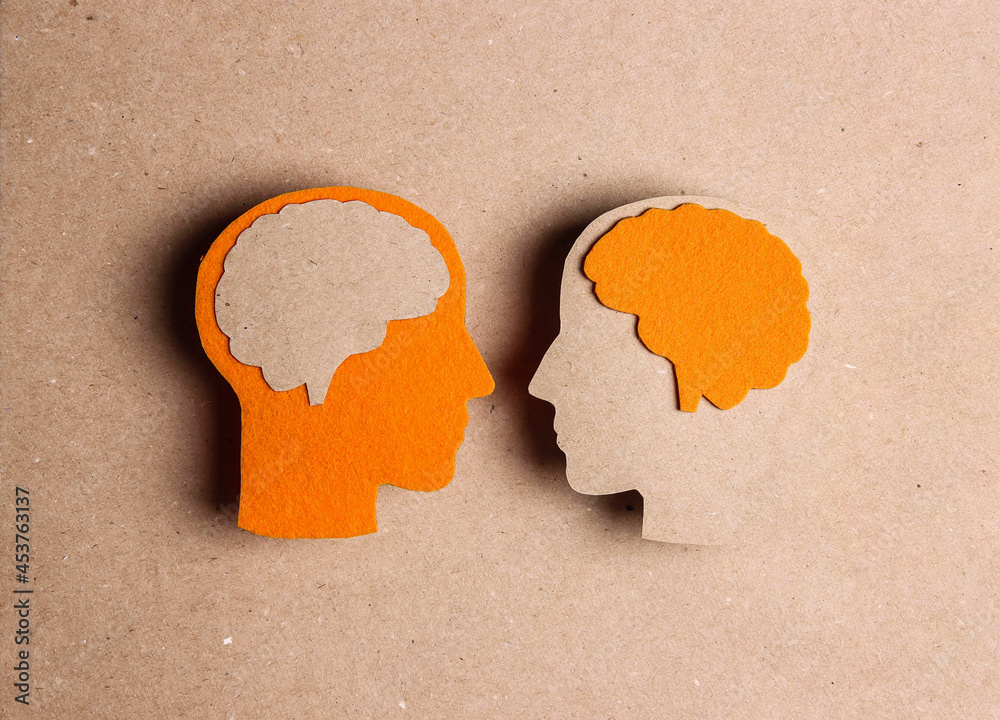 Poster Cardboard profiles with brain symbol on a brown background ...