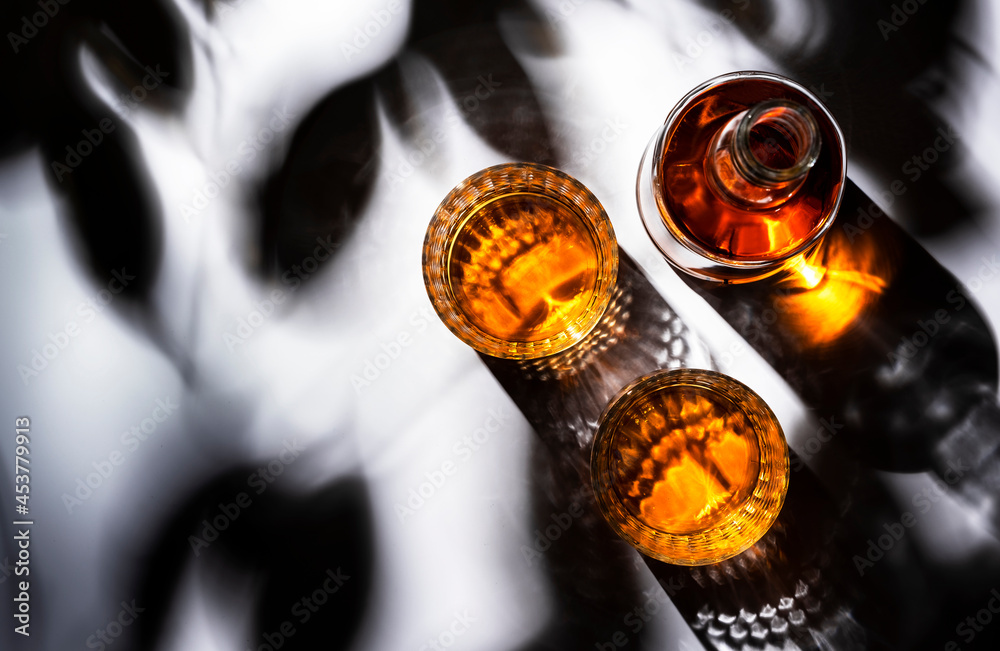 American bourbon whiskey in glasses and bottle, white background with ...