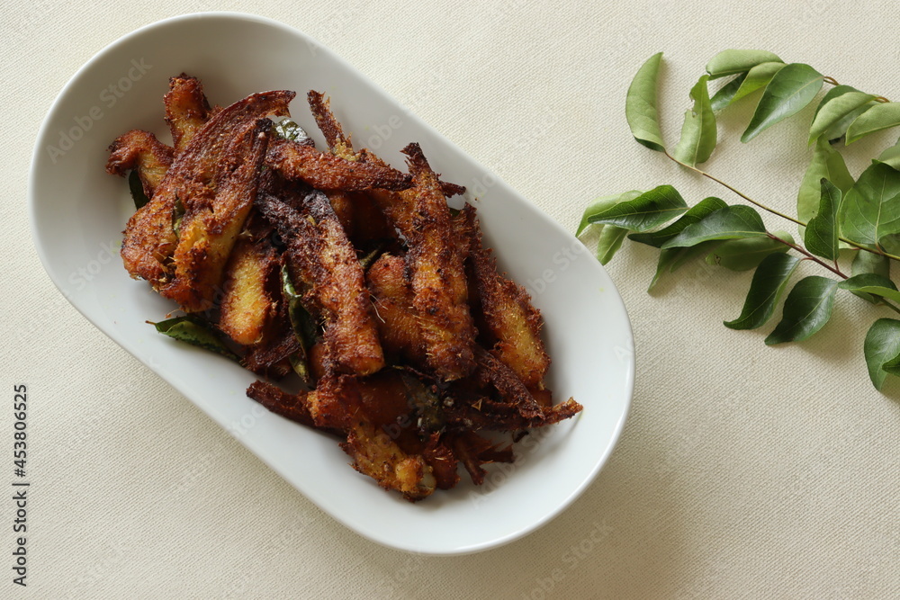 Crispy and spicy Anchovy fry. Anchovies marinated with spices and deep ...