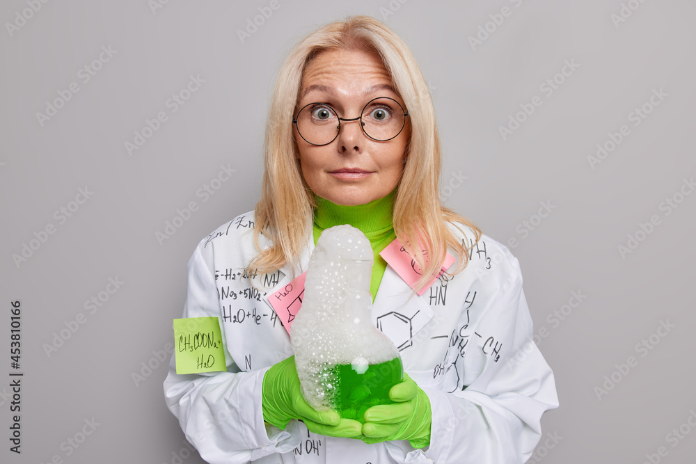 Surprised professional chemist studies chemical substances and how they ...