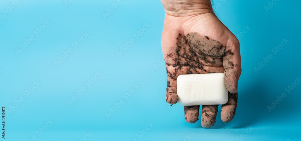 Global Handwashing Day, personal hygiene concept. Dirty hand holds soap ...