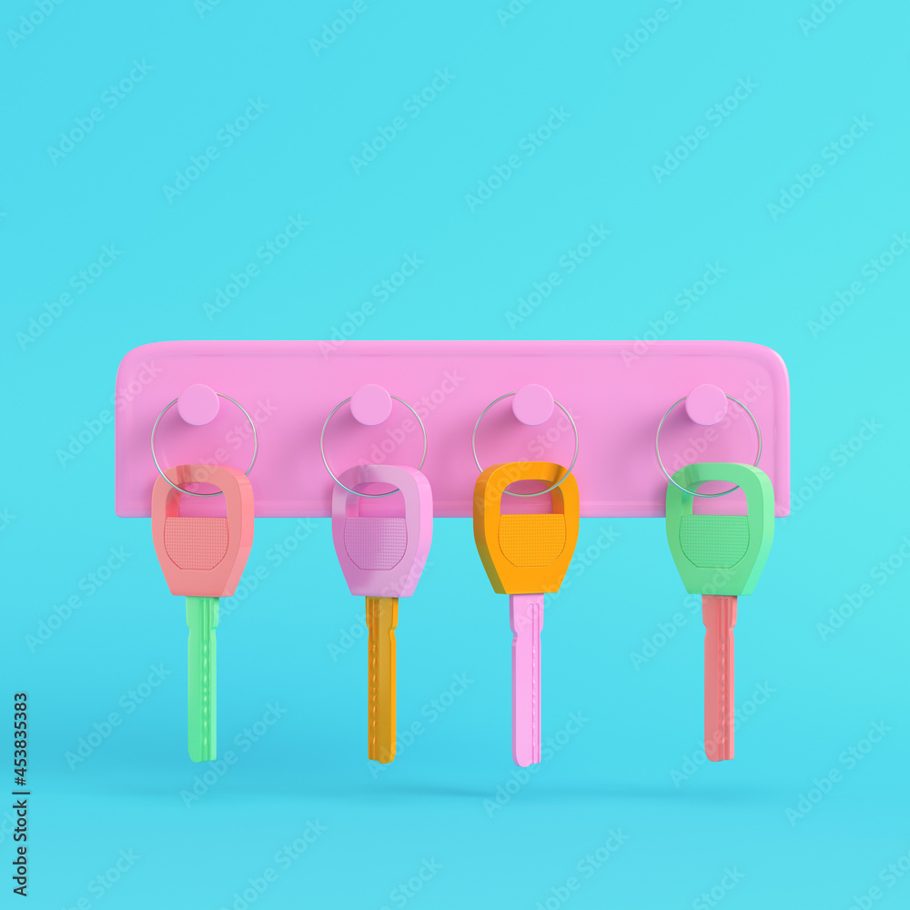 Colorful keys on keyholder on bright blue background in pastel colors ...