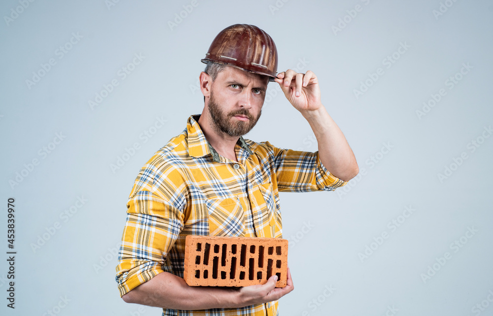 man build house. mature builder in shirt. unshaven man on construction ...