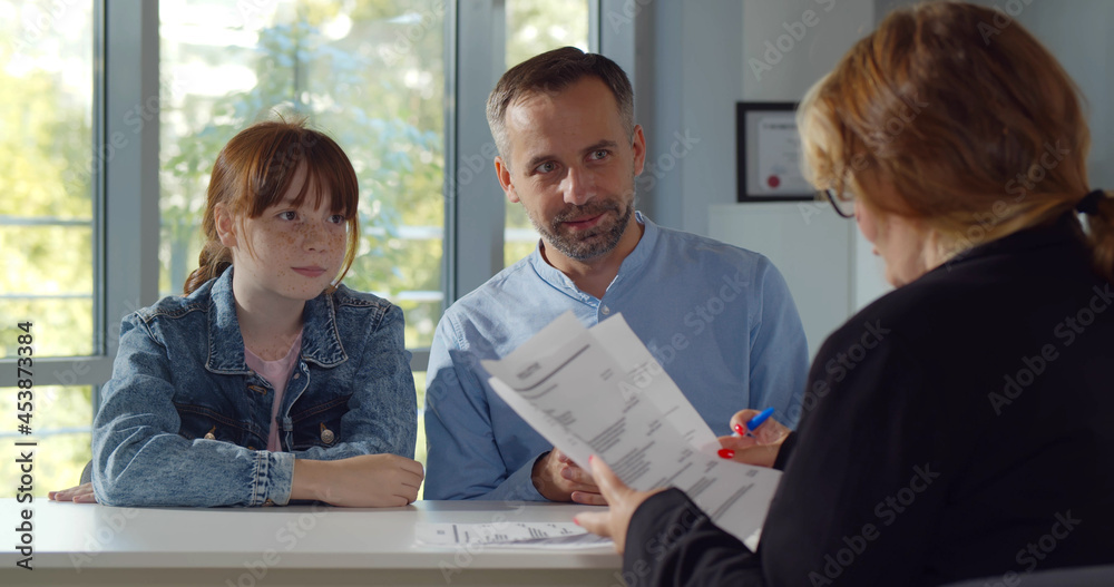 Foto de Back view of female headmaster interview father and preteen ...