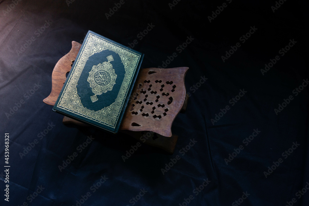 Quran in the mosque - open for prayers The black background of the ...