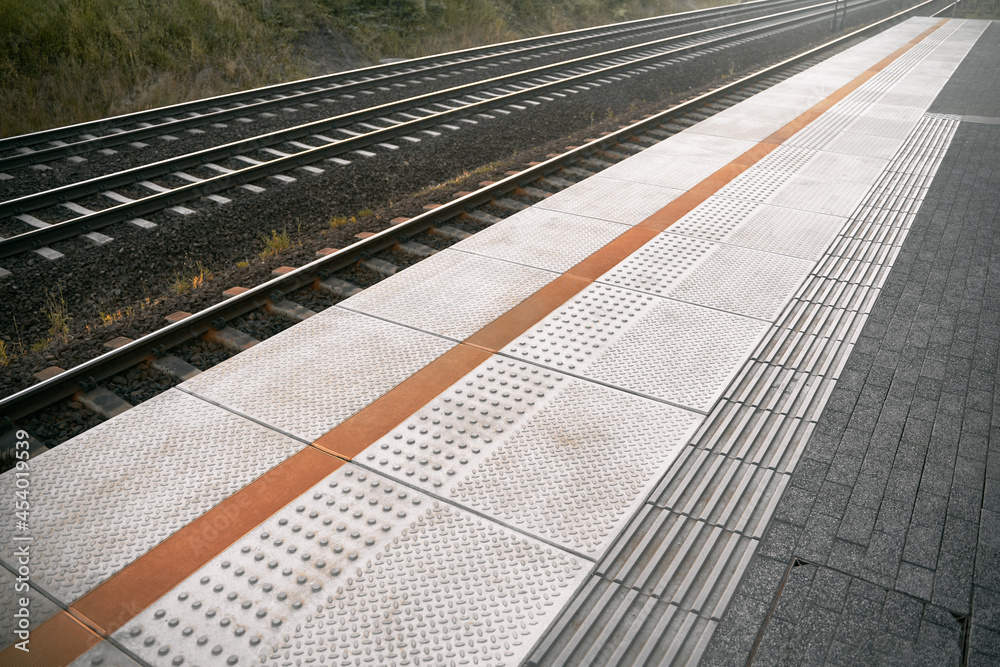 Train platform with tactile dotted pavement for handicapped people ...