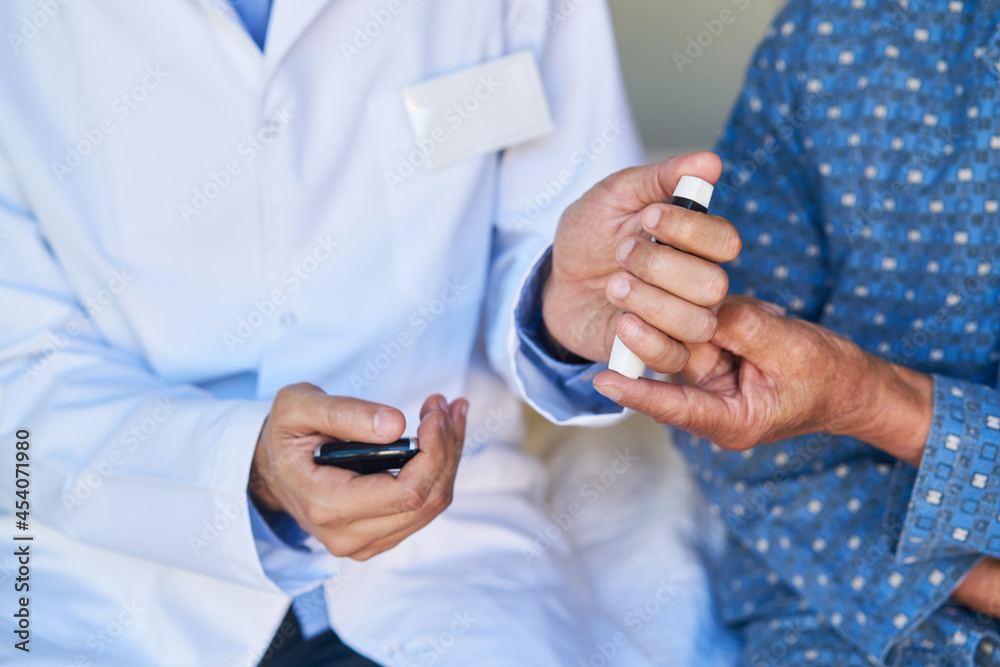 Blood is drawn from the finger with the lancet Stock Photo | Adobe Stock