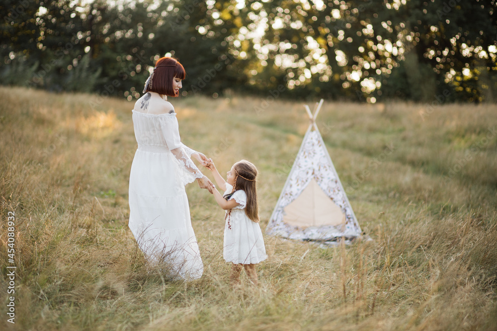 Happy stunning native American mother dancing with her adorable little ...
