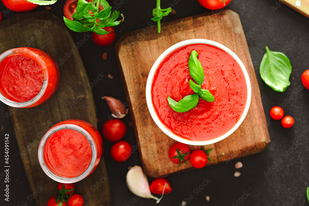 Tomato passata with basilium and garlic. Stock Photo | Adobe Stock
