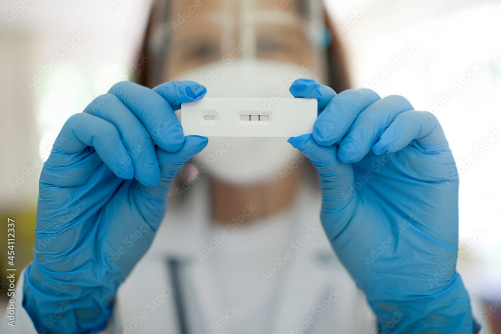 Asian doctor wearing blue gloves and hygiene protective face mask ...