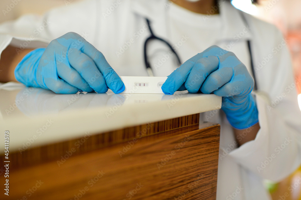 Asian doctor wearing blue gloves and hygiene protective face mask ...
