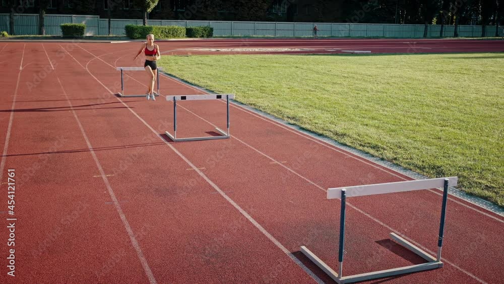 Stockvideon Running with obstacles. The blonde girl trains in the ...