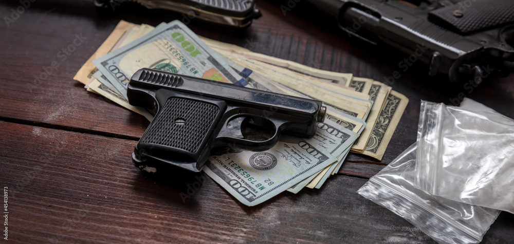 Drugs narcotics business concept. Cocaine plastic packets, gun and US ...