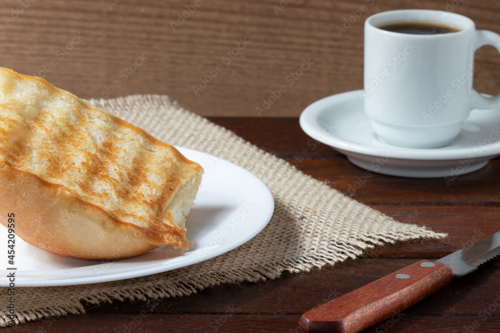 Brazilian traditional pão na chapa, bread toasted with butter and black ...