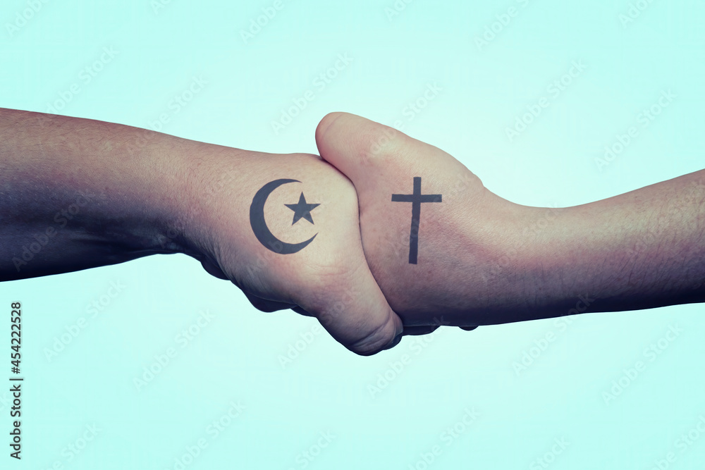 Shaking hands with a Muslim religious symbol and Christian religious ...