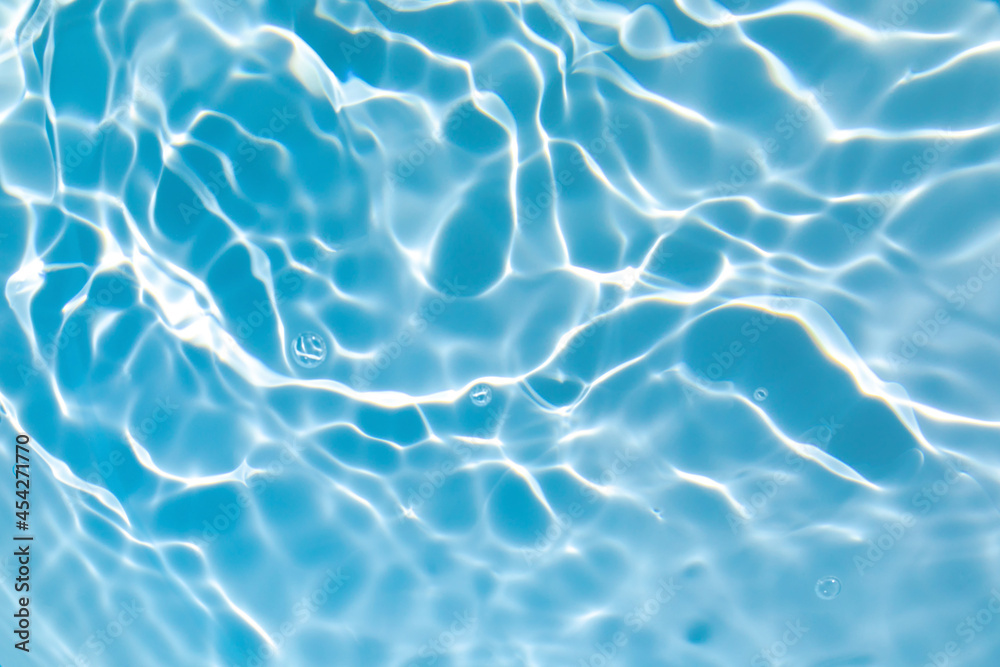 De-focused blurred transparent blue colored clear calm water surface ...