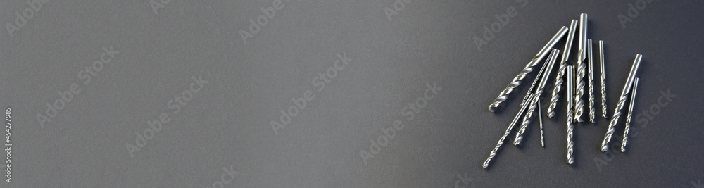 Drills for metal lie on a black paper background. Hole processing tool ...