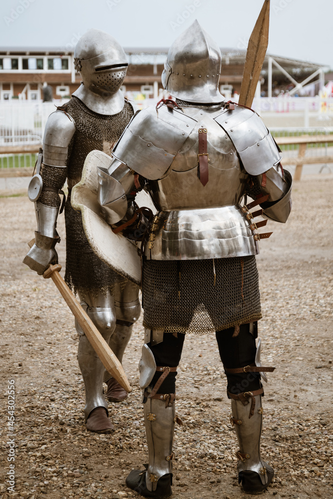 Two medieval knights in heavy armor are ready for battle. Modern ...