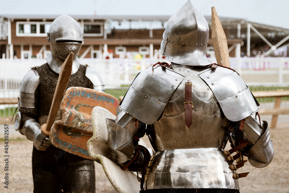 Two medieval knights in heavy armor are ready for battle. Modern ...