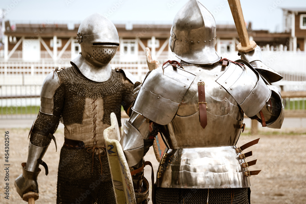 Two medieval knights in heavy armor are ready for battle. Modern ...