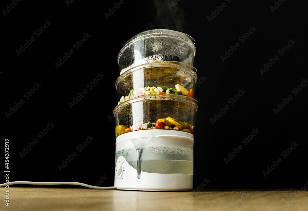 Cooking in the steamer. Healthy, diet food preparing in a steam cooker ...
