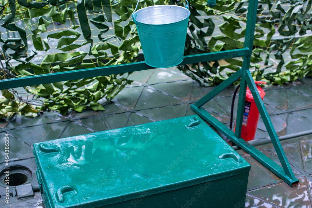 Fire safety. fire shield, a metal container with sand, a bucket and a ...