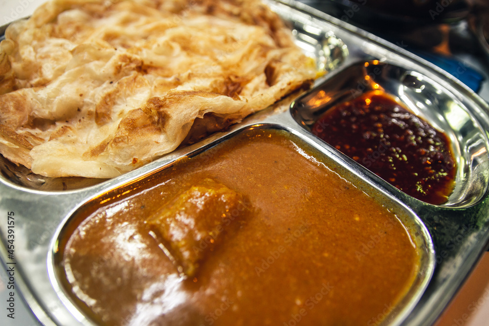 Roti canai served in an Indian restaurant. Also known as roti chenai ...