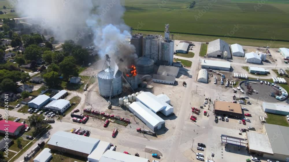 2021 - Aerial over an industrial fire in a grain silo storage facility ...