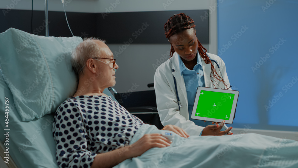 Specialist woman showing green screen on tablet to patient feeling sick ...
