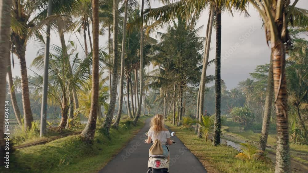 travel woman riding motorcycle on tropical island road trip enjoying ...