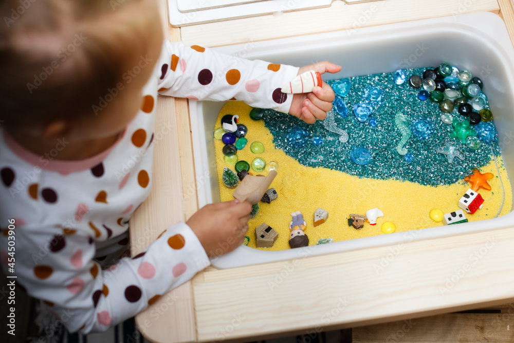 Cute Caucasian baby toddler playing with sensory table, in touch box ...