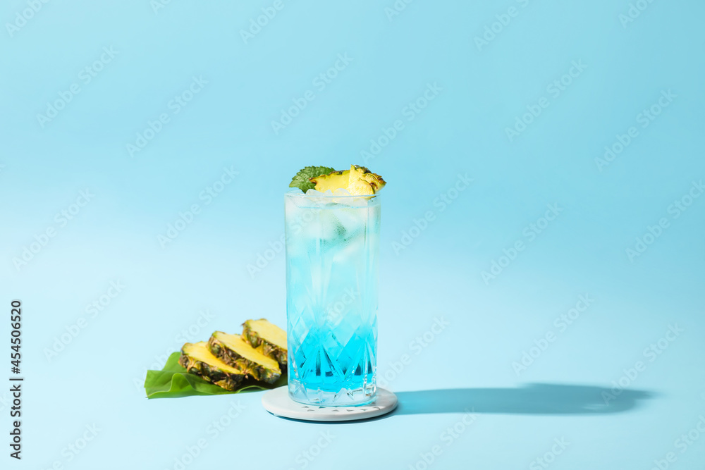 Glass of Blue Lagoon cocktail on color background Stock Photo | Adobe Stock