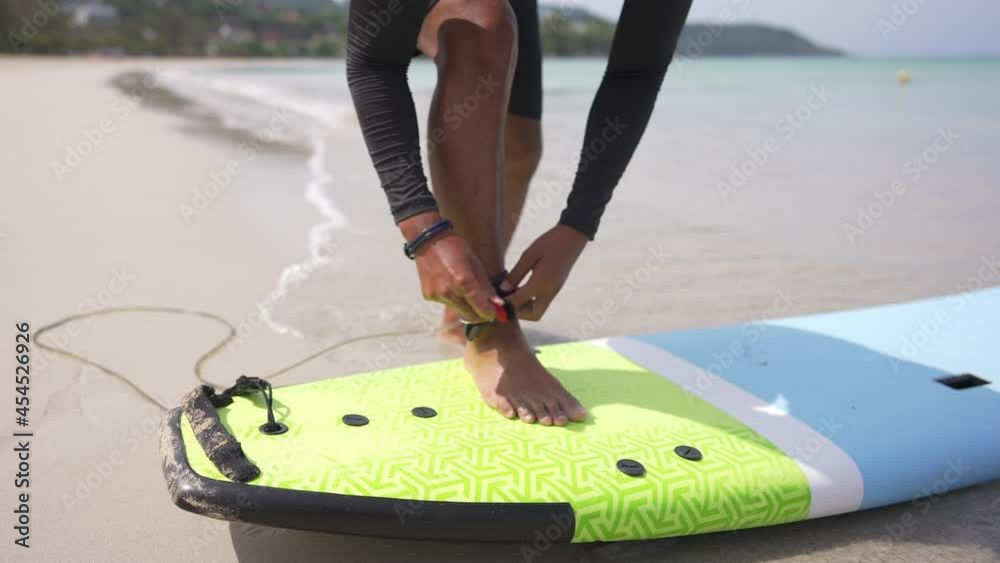 4K Confidence Asian man in wetsuit wear surfboard safety leg rope ...