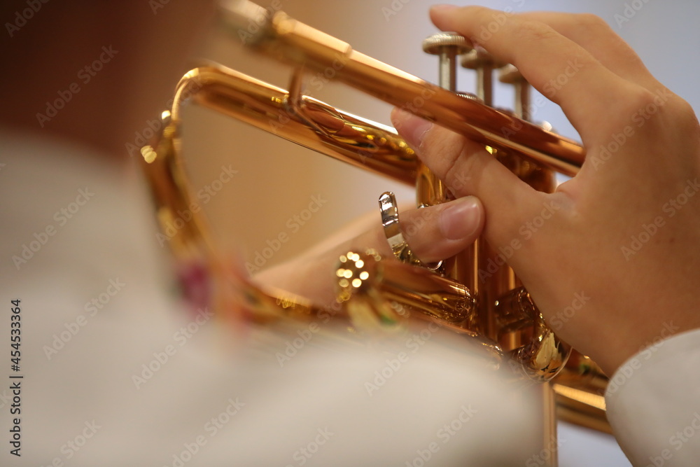 Musical instrument in hand with finger on key of trumpet valve. Music ...